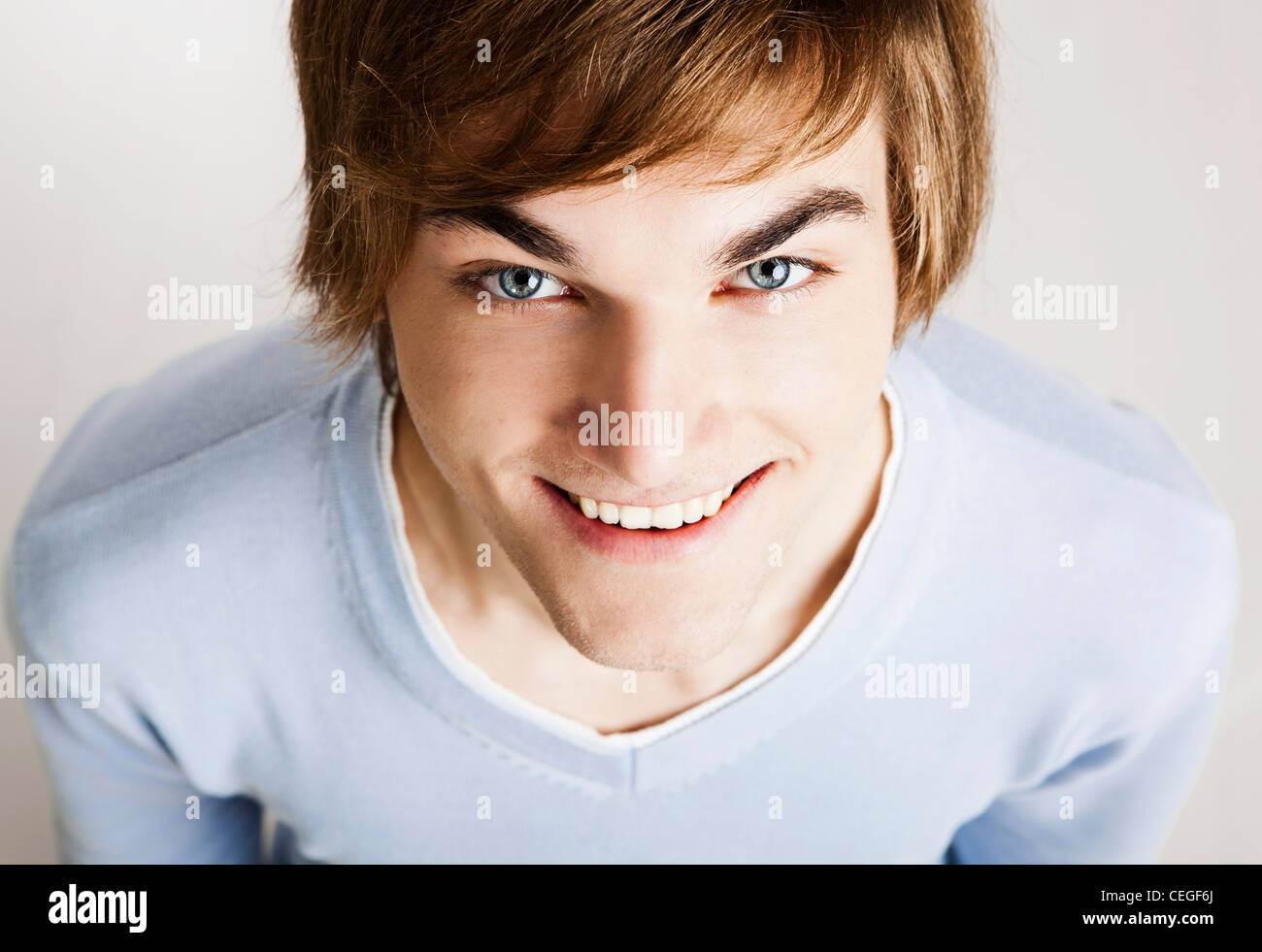 Portrait of a handsome young man looking up and laughing Stock Photo ...