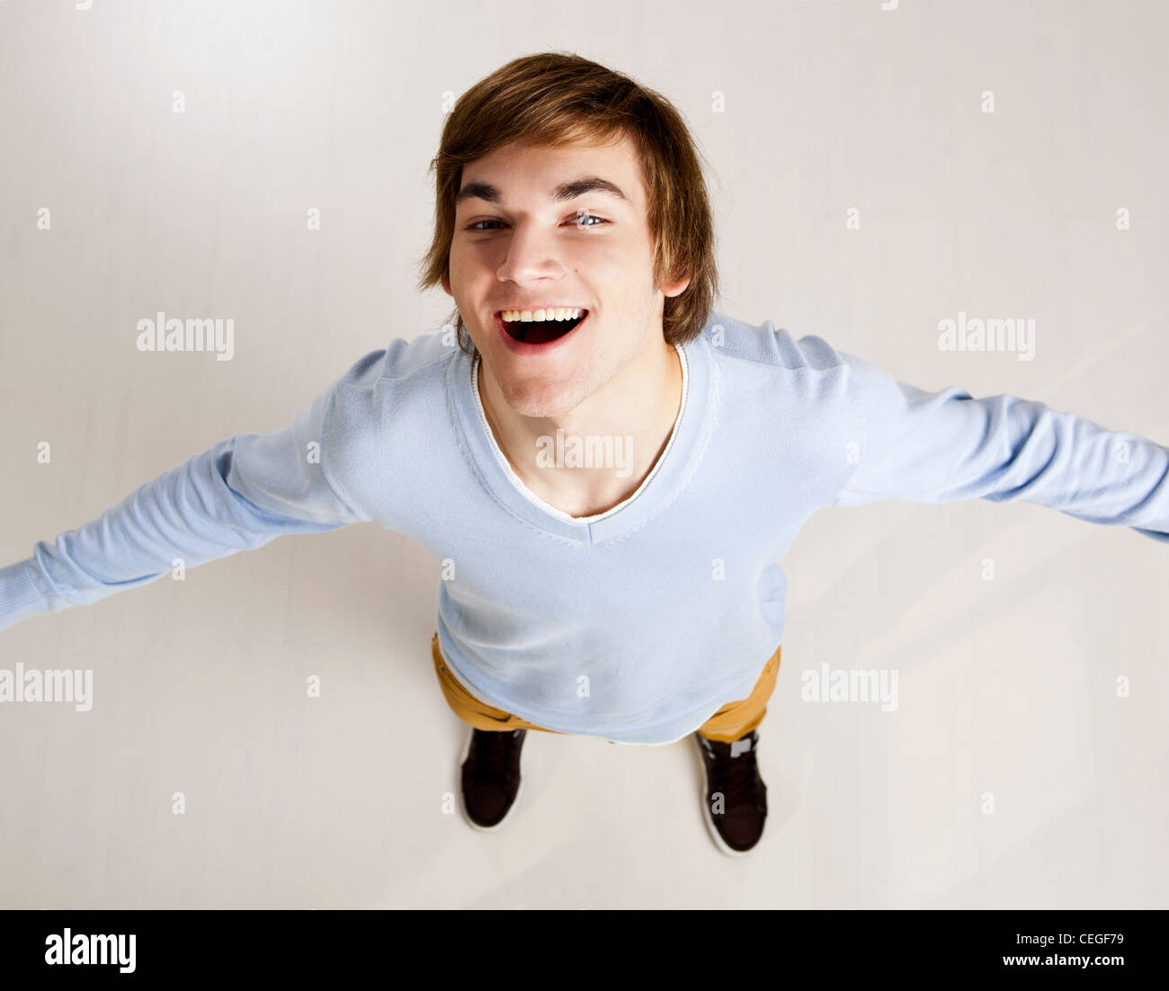 Portrait of a handsome young man looking up and laughing Stock Photo ...