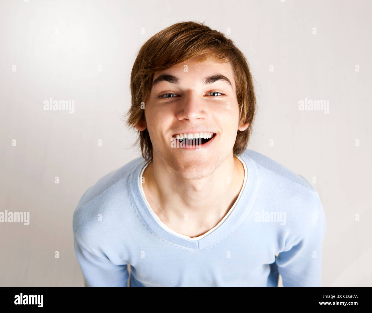 Portrait of a handsome young man looking up and laughing Stock Photo ...