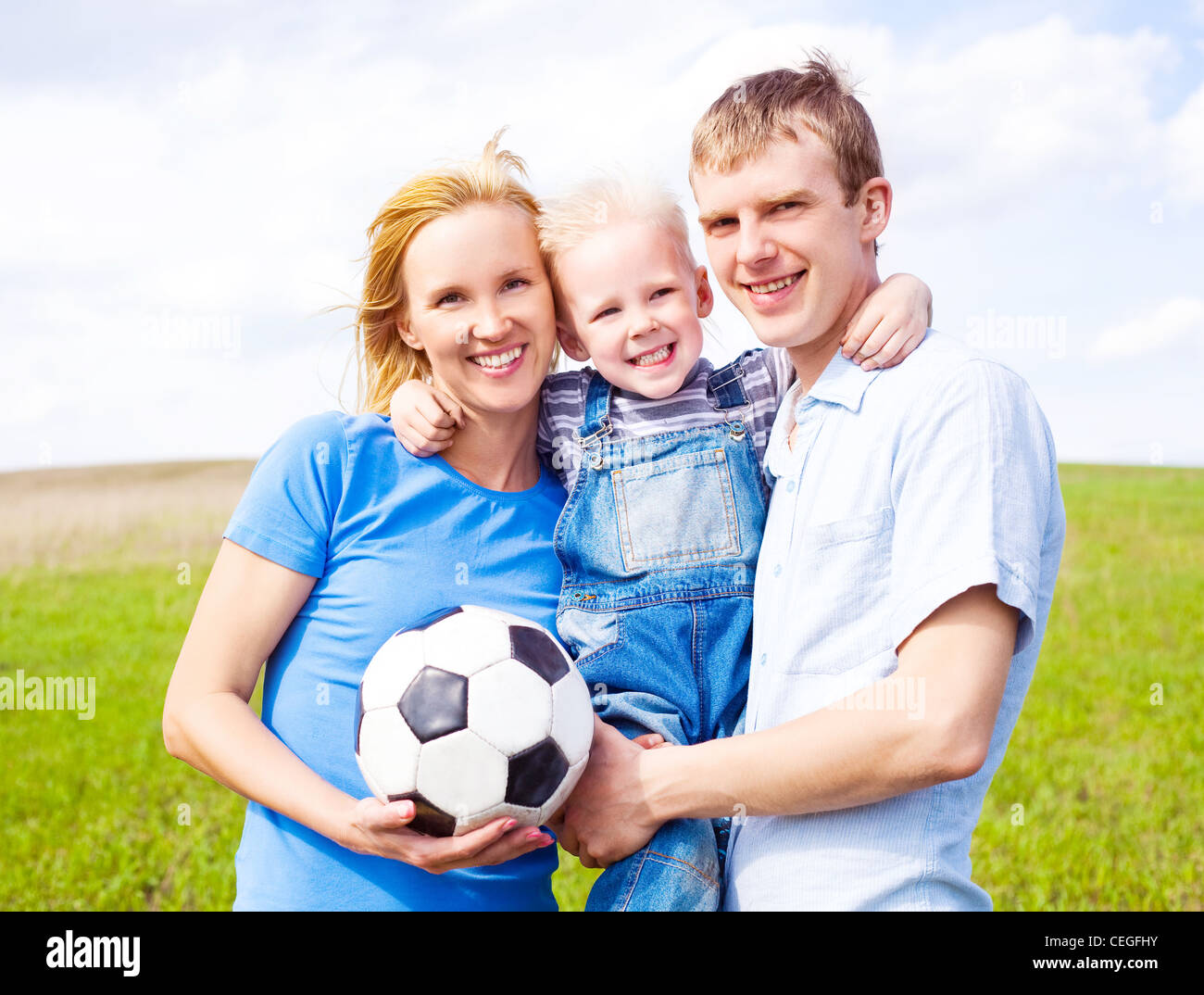 happy family playing football Stock Photo - Alamy