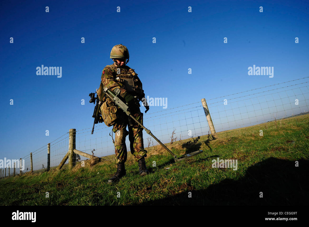 A British army solder 'Vallon man' looking for IED's using a Vallon ...