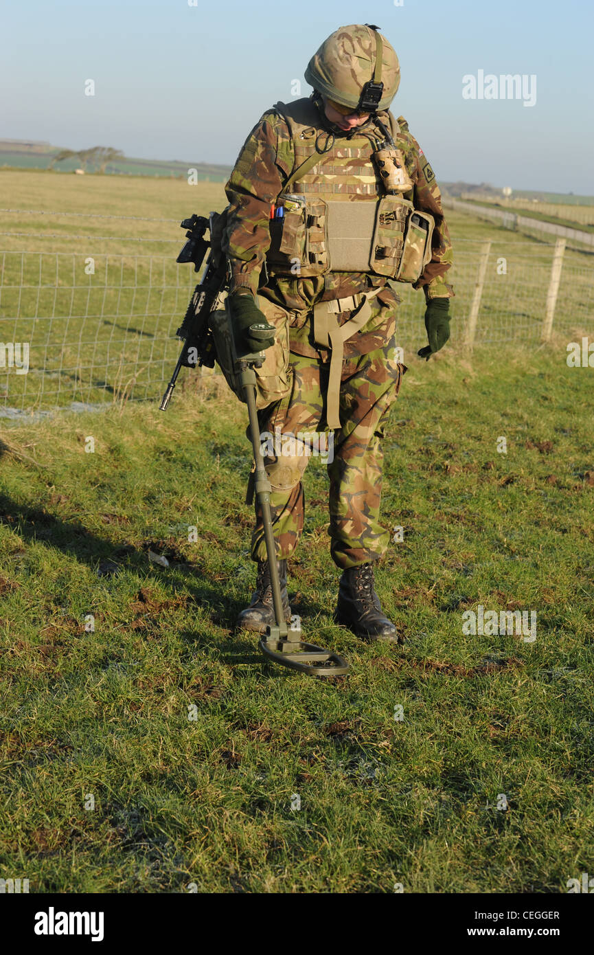 A British army solder 'Vallon man' looking for IED's using a Vallon ...