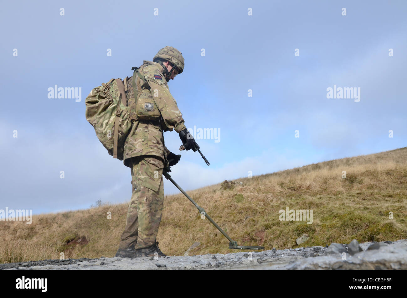 A British army solder 'Vallon man' looking for IED's using a Vallon ...