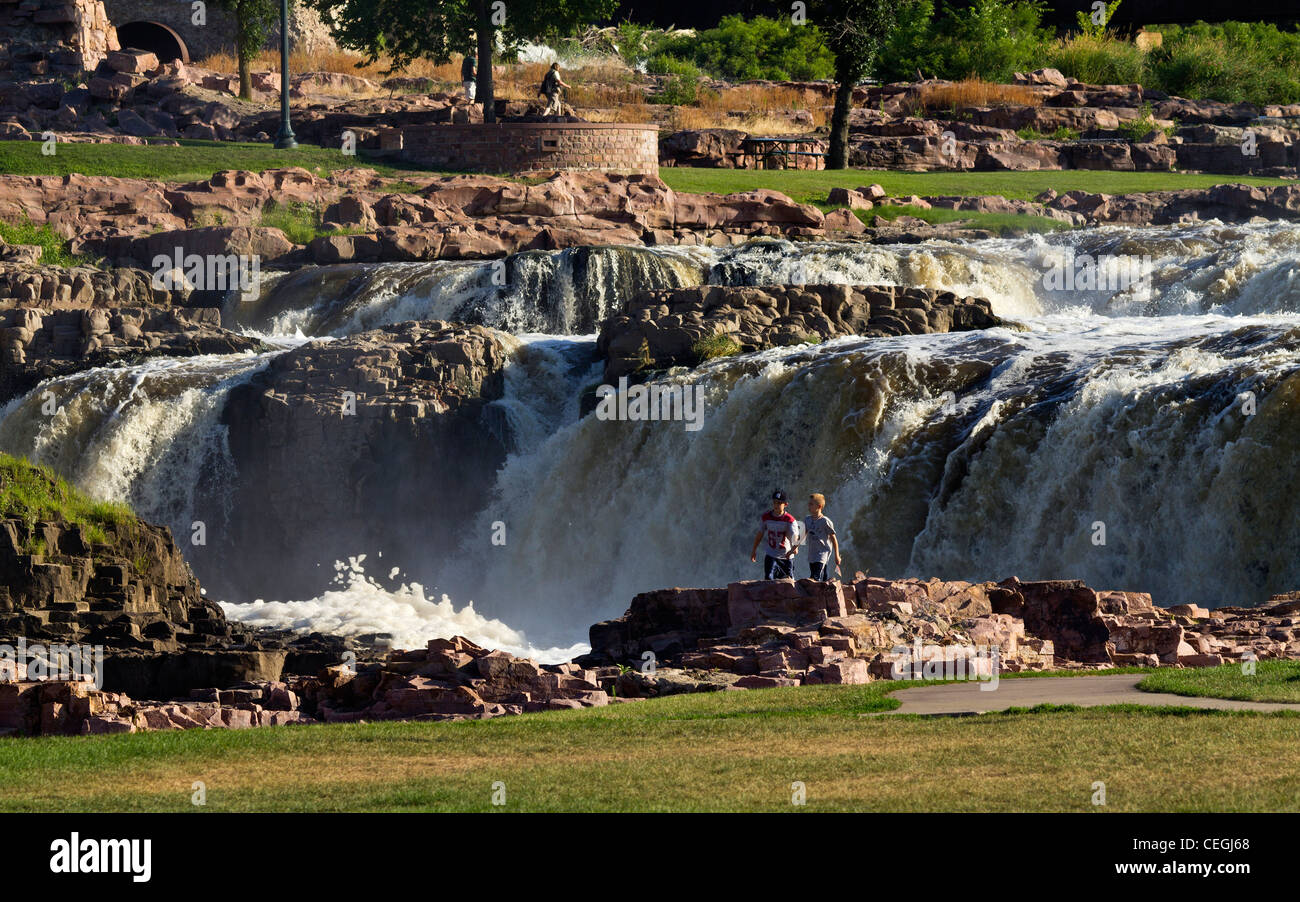 A couple standing by waterfall rear view American Sioux Falls Big Sioux ...