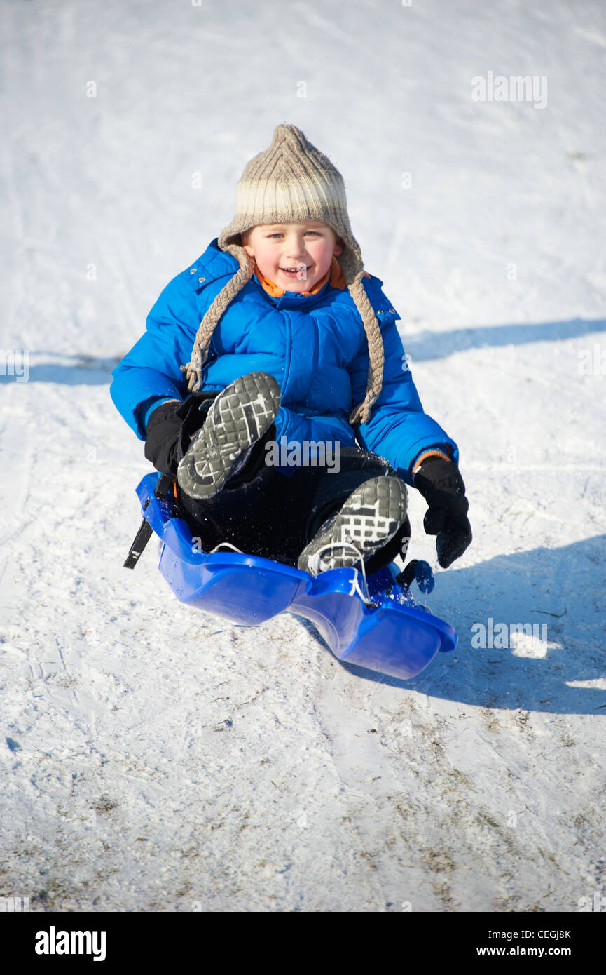 A child little boy sledding downhill winter Stock Photo - Alamy