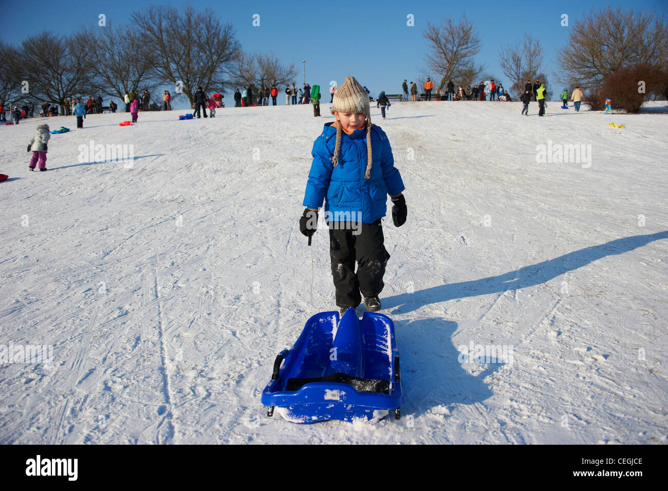 A child little boy sledding downhill winter Stock Photo - Alamy