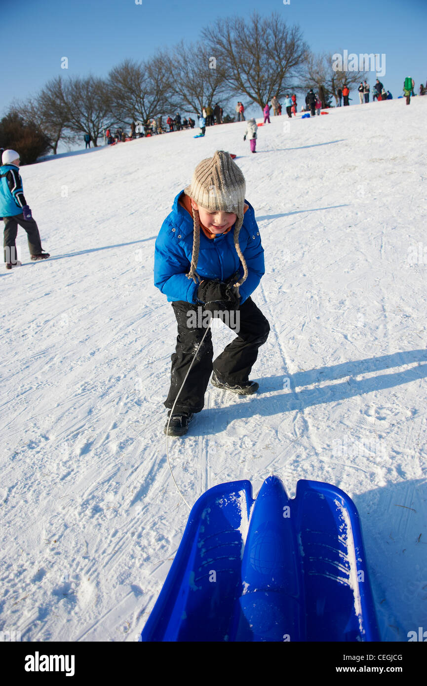 A child little boy sledding downhill winter Stock Photo - Alamy