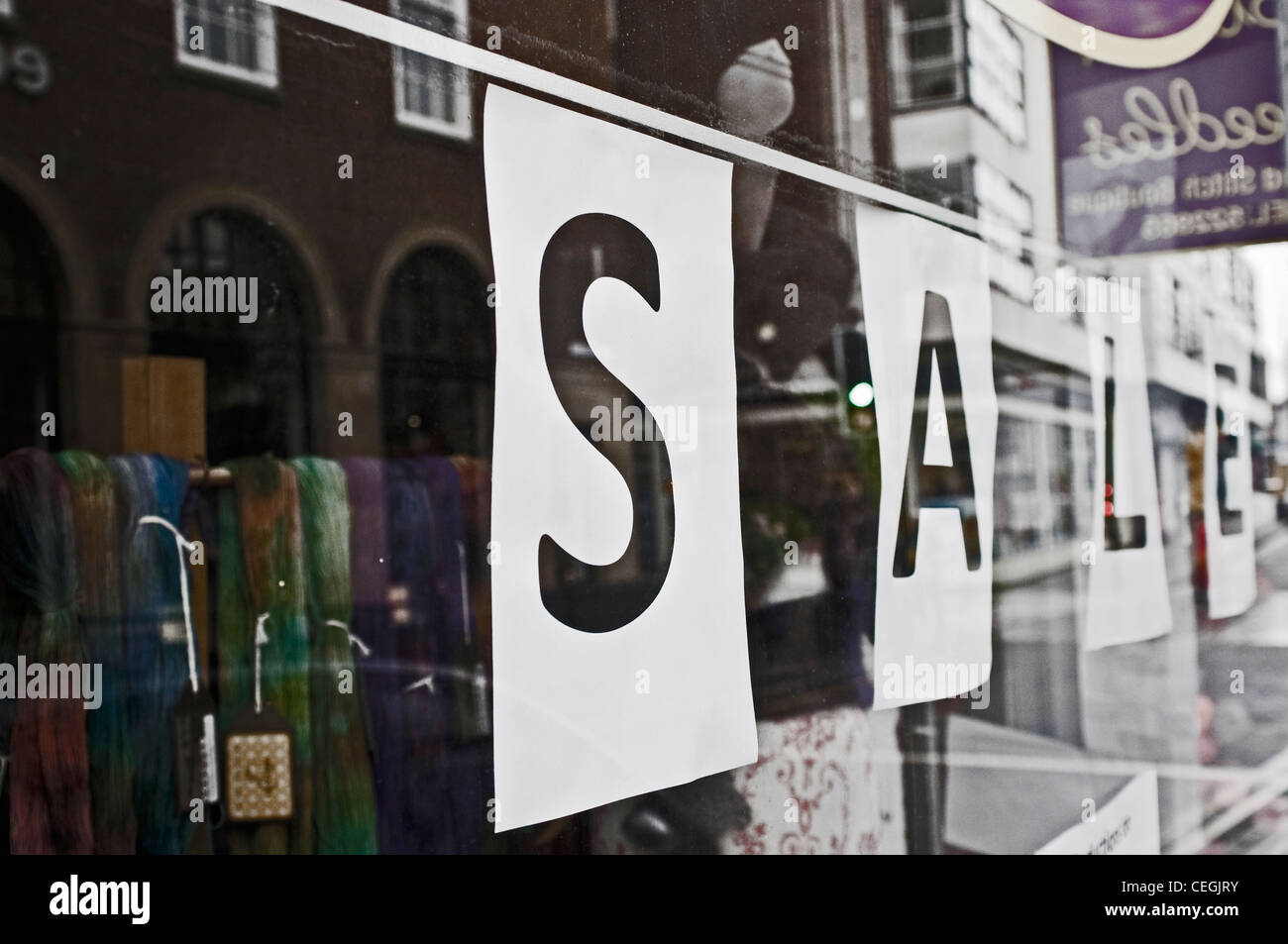 A sale sign in a shop window front Stock Photo - Alamy