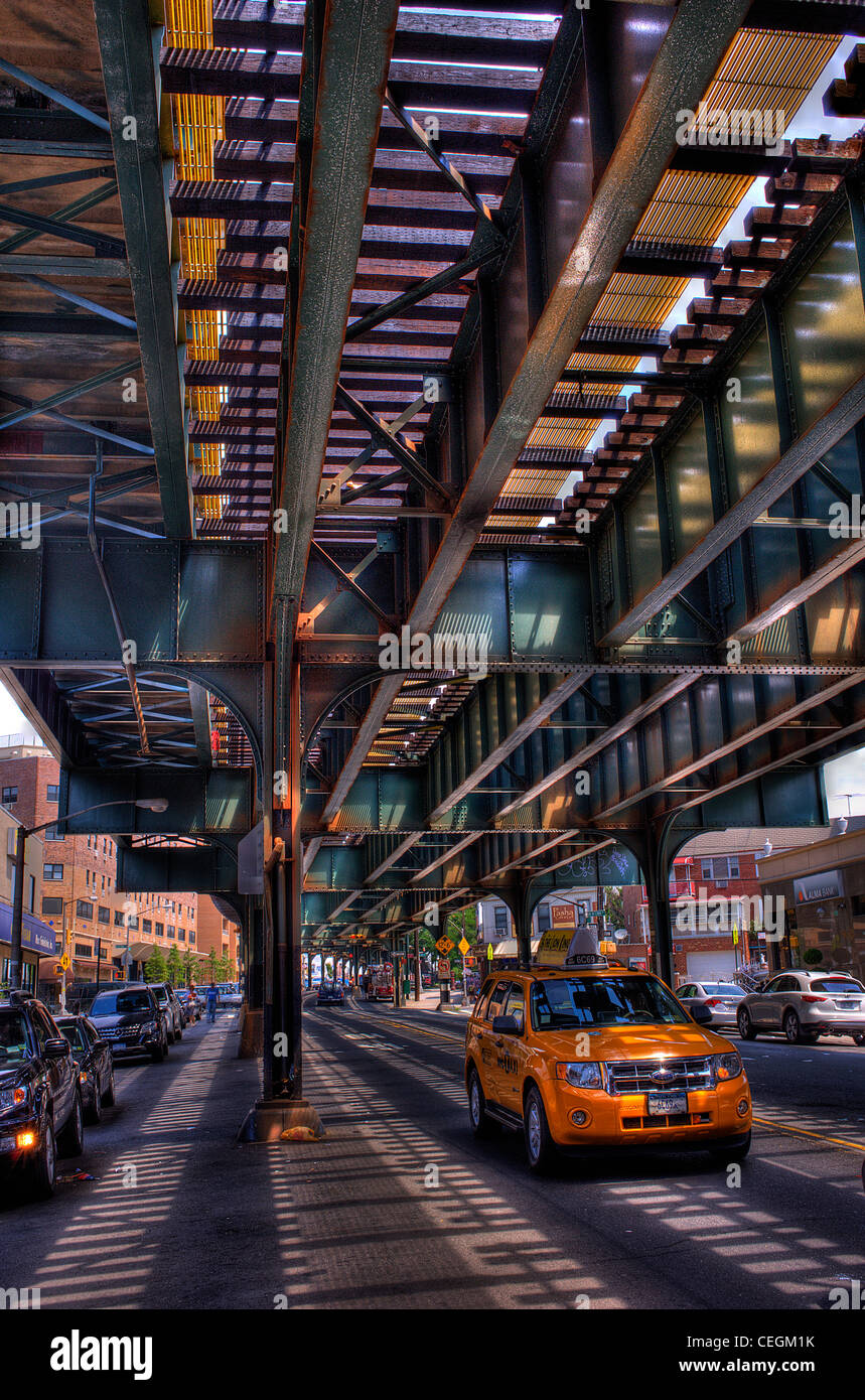 Taxi Cab driving under elevated train Stock Photo - Alamy