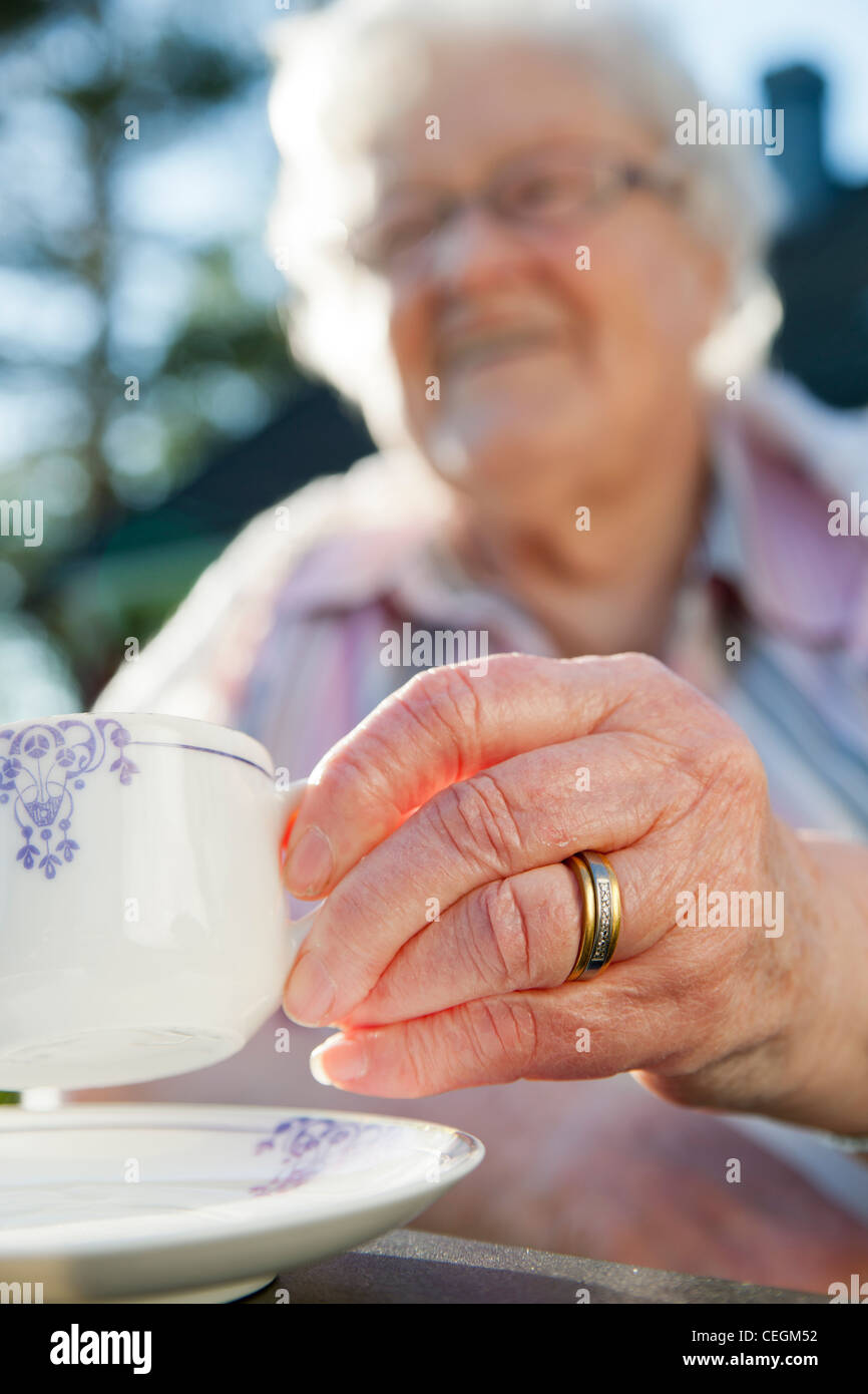 Old woman drinking coffee Stock Photo - Alamy