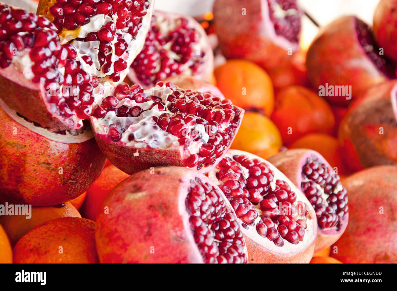 Detail of an open pomegranate with whole ones in the background Stock ...