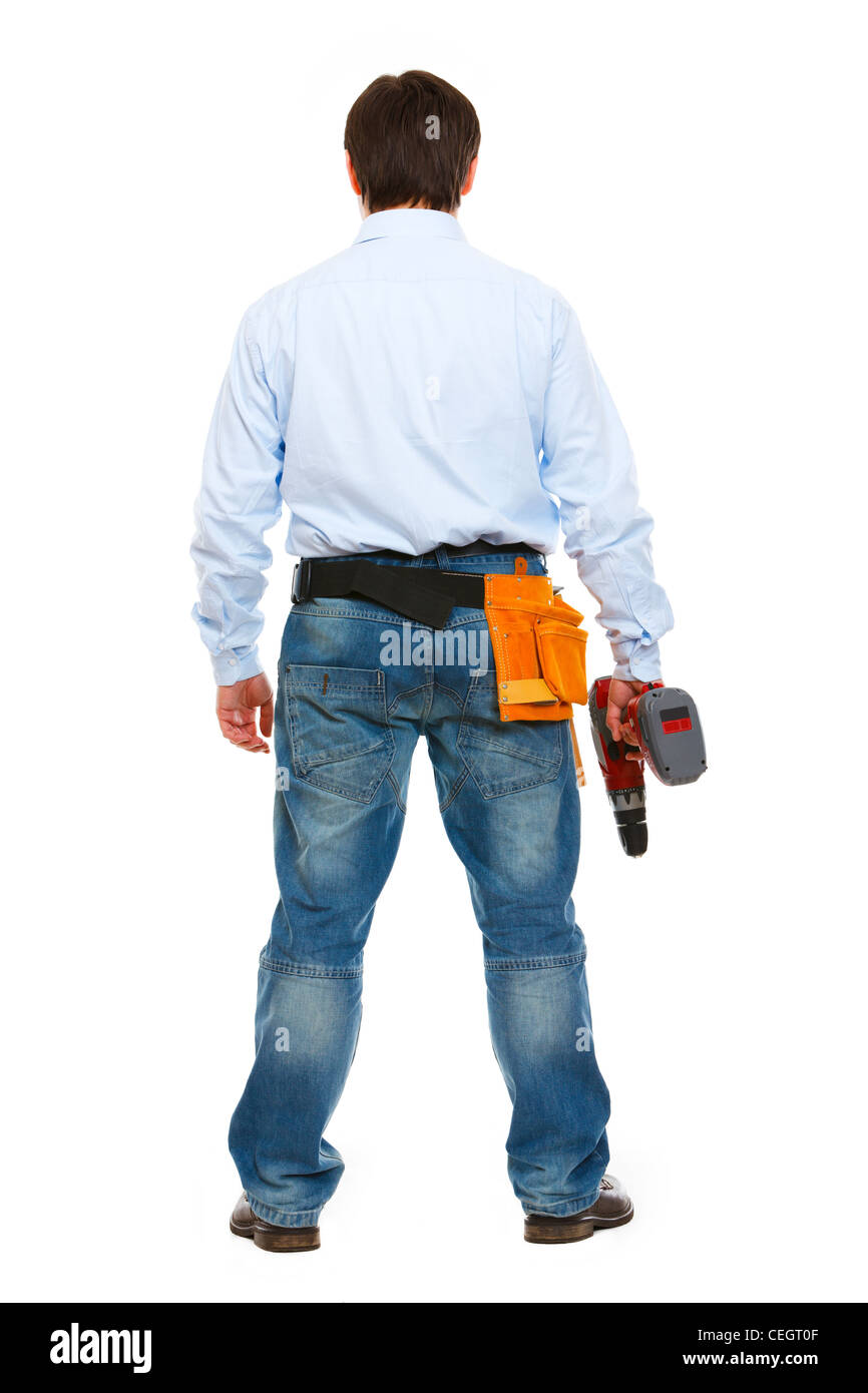 Full length portrait of construction worker standing back to camera ...