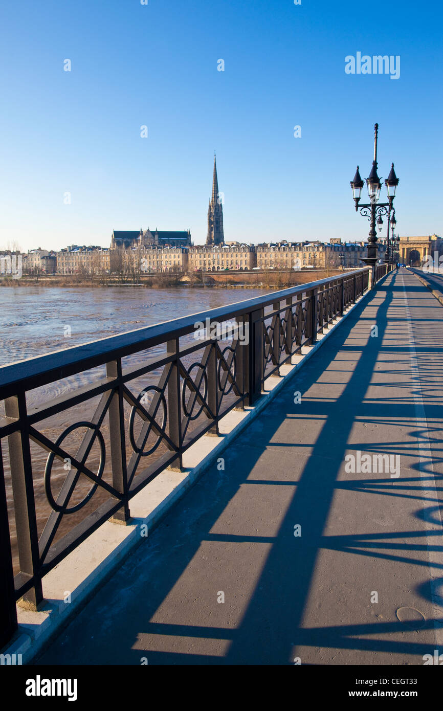 Pont de Pierre bridge crossing La Garonne River, with St Michel Tower ...
