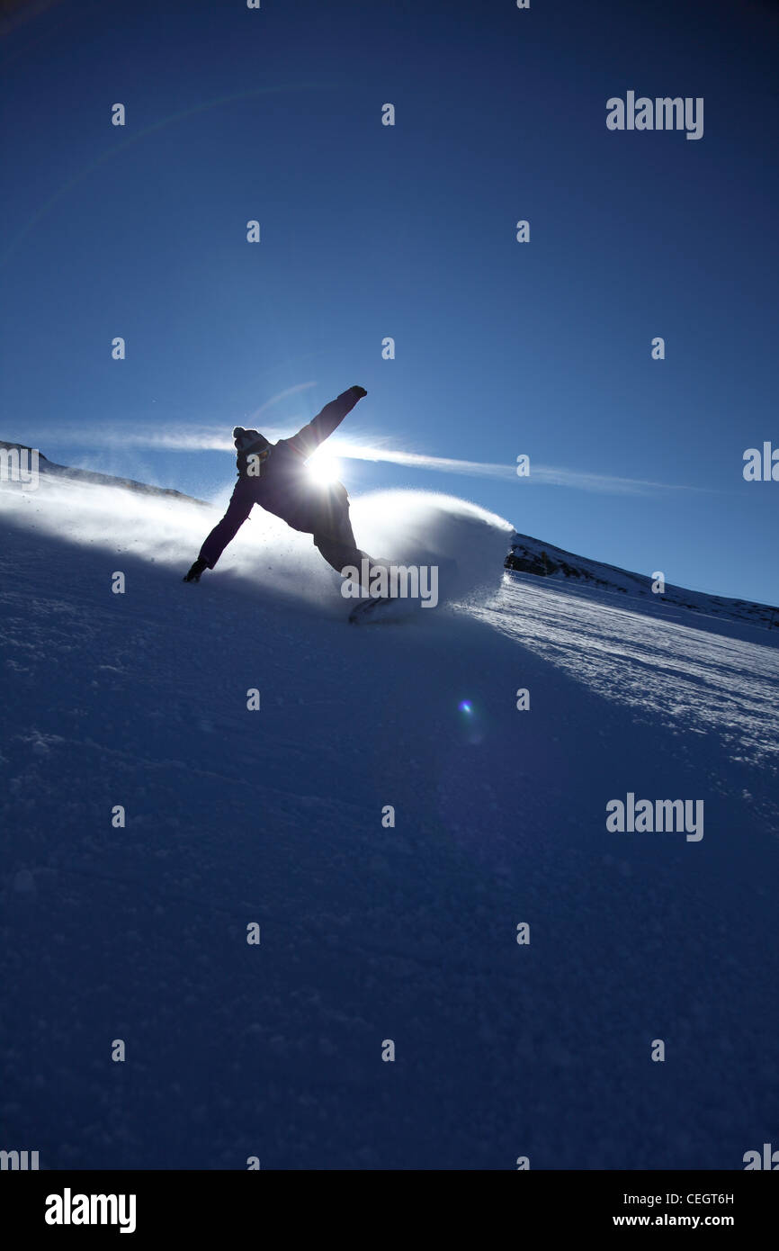 Male snowboarder sliding down ski slope Stock Photo - Alamy