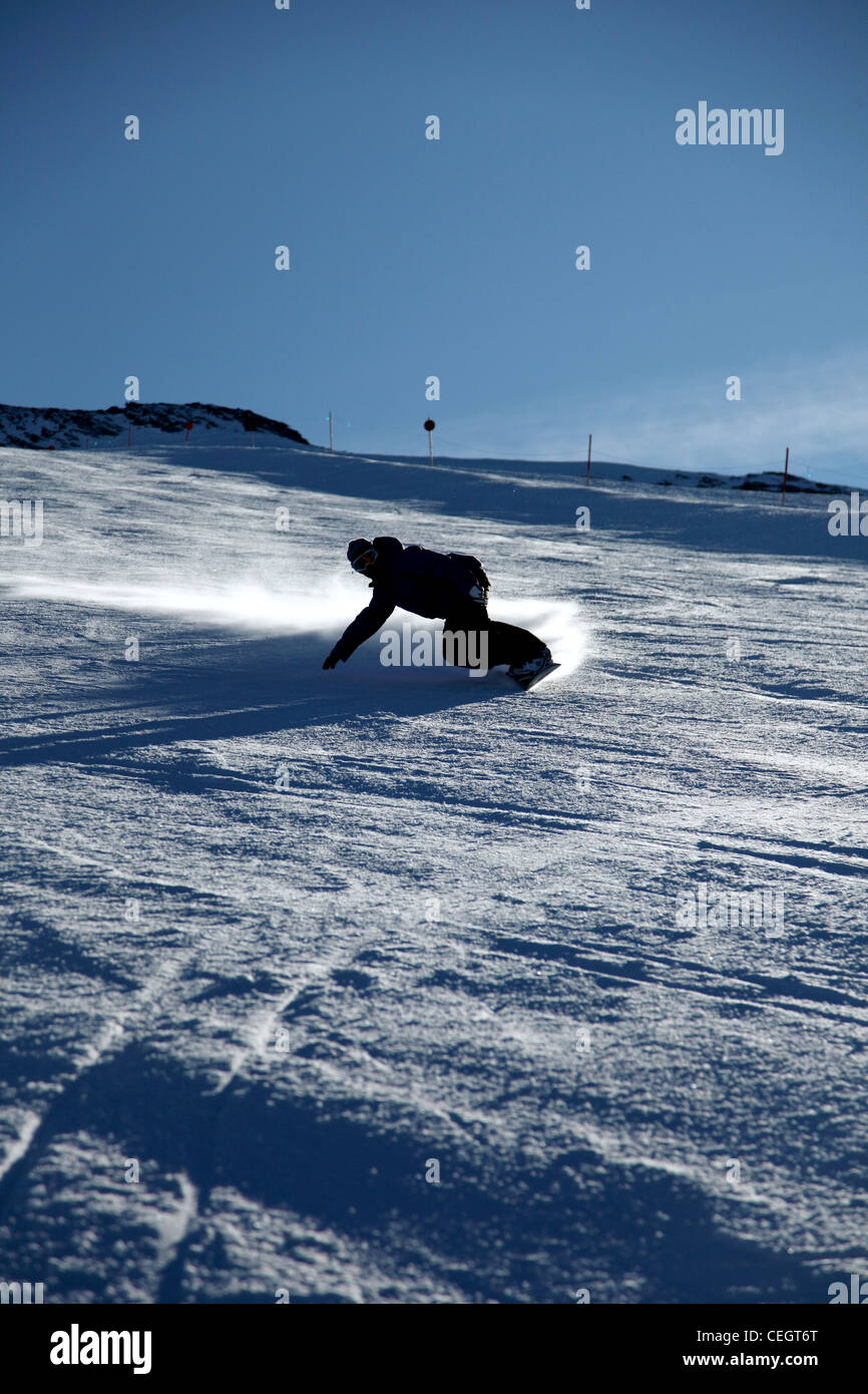 Male snowboarder sliding down ski slope Stock Photo - Alamy