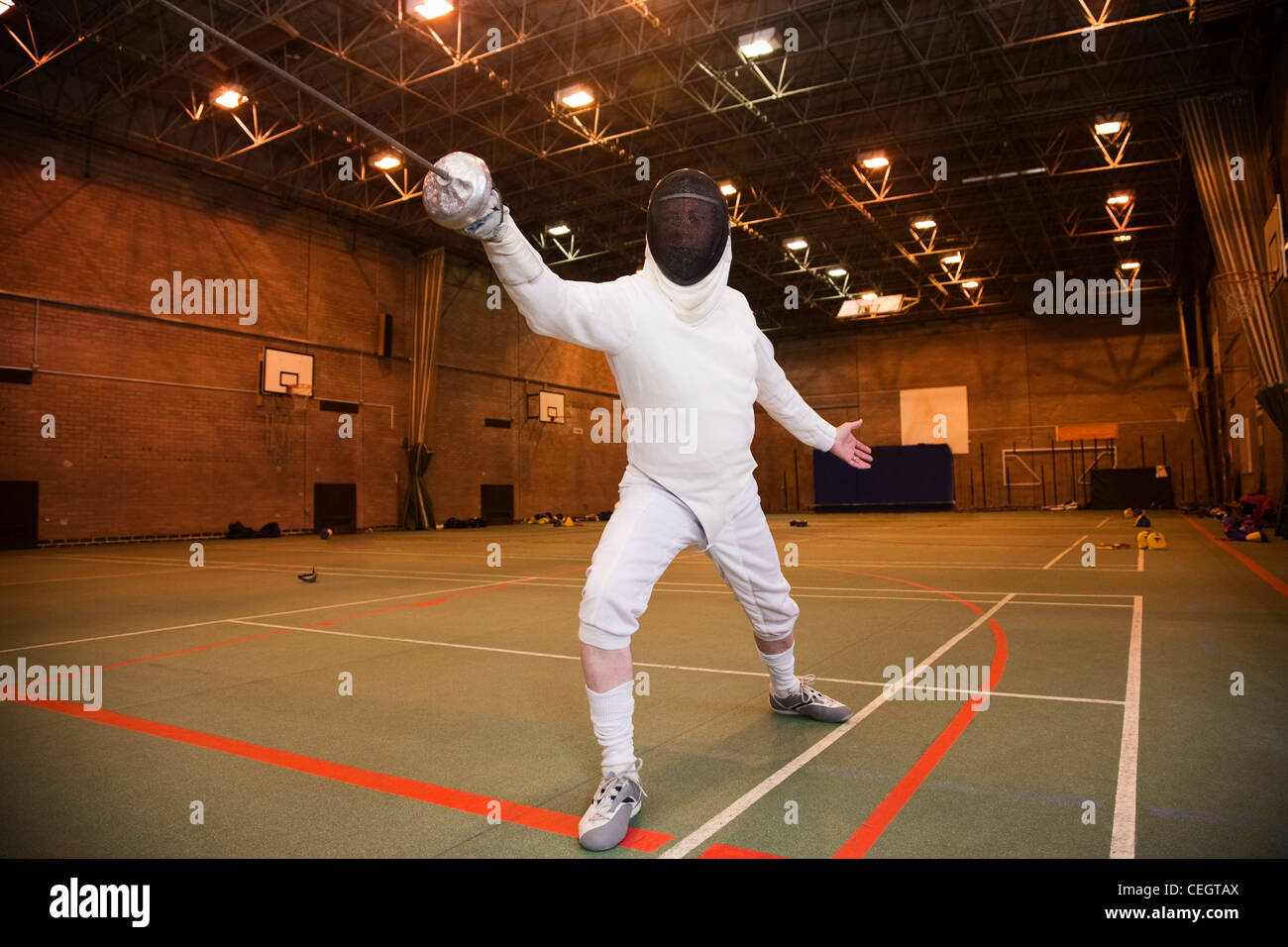 Senior man in fencing suit holding foil Stock Photo - Alamy