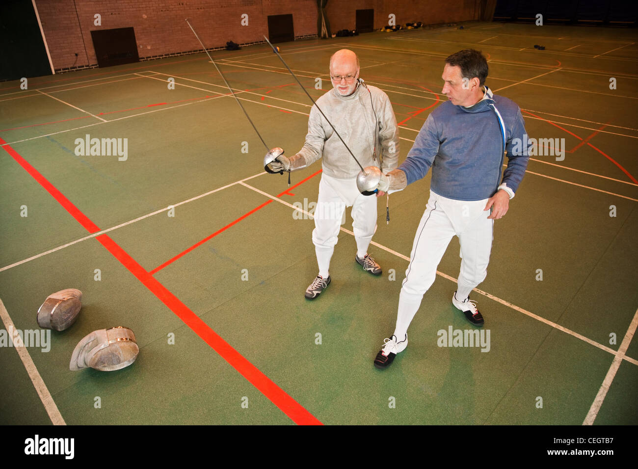 Senior and mature men fencing together Stock Photo - Alamy