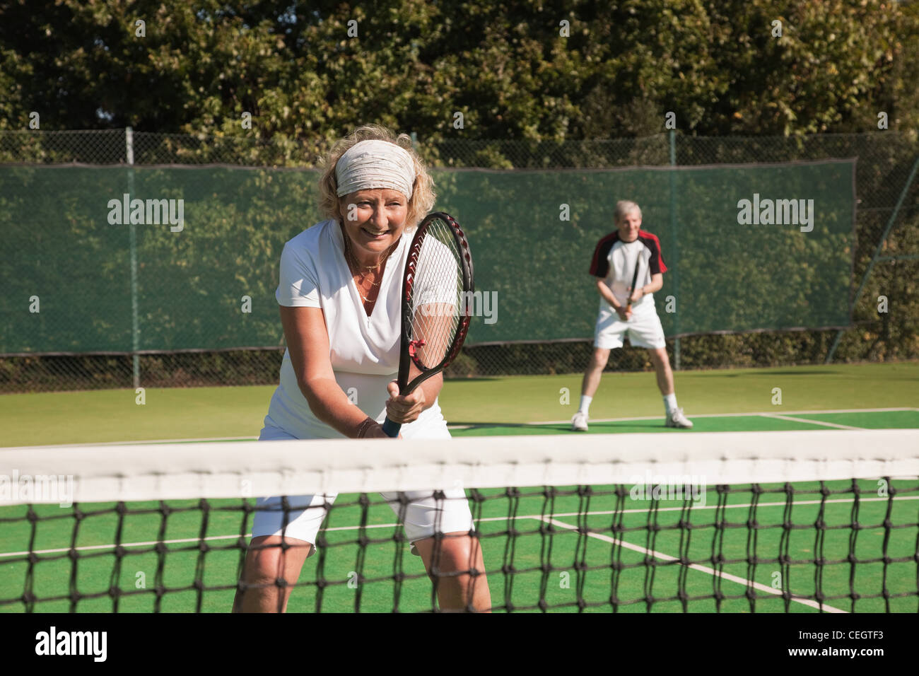 Senior and mature adults playing tennis Stock Photo - Alamy