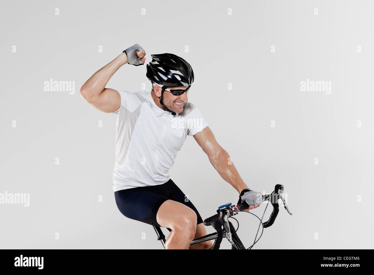 Male cyclist cheering Stock Photo - Alamy