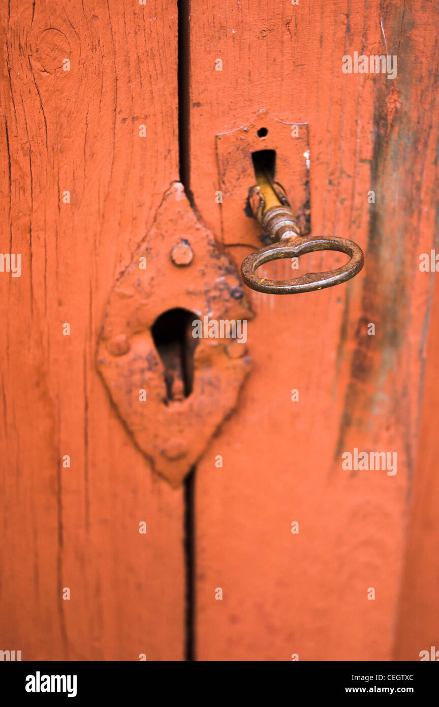 Key and red door Stock Photo - Alamy