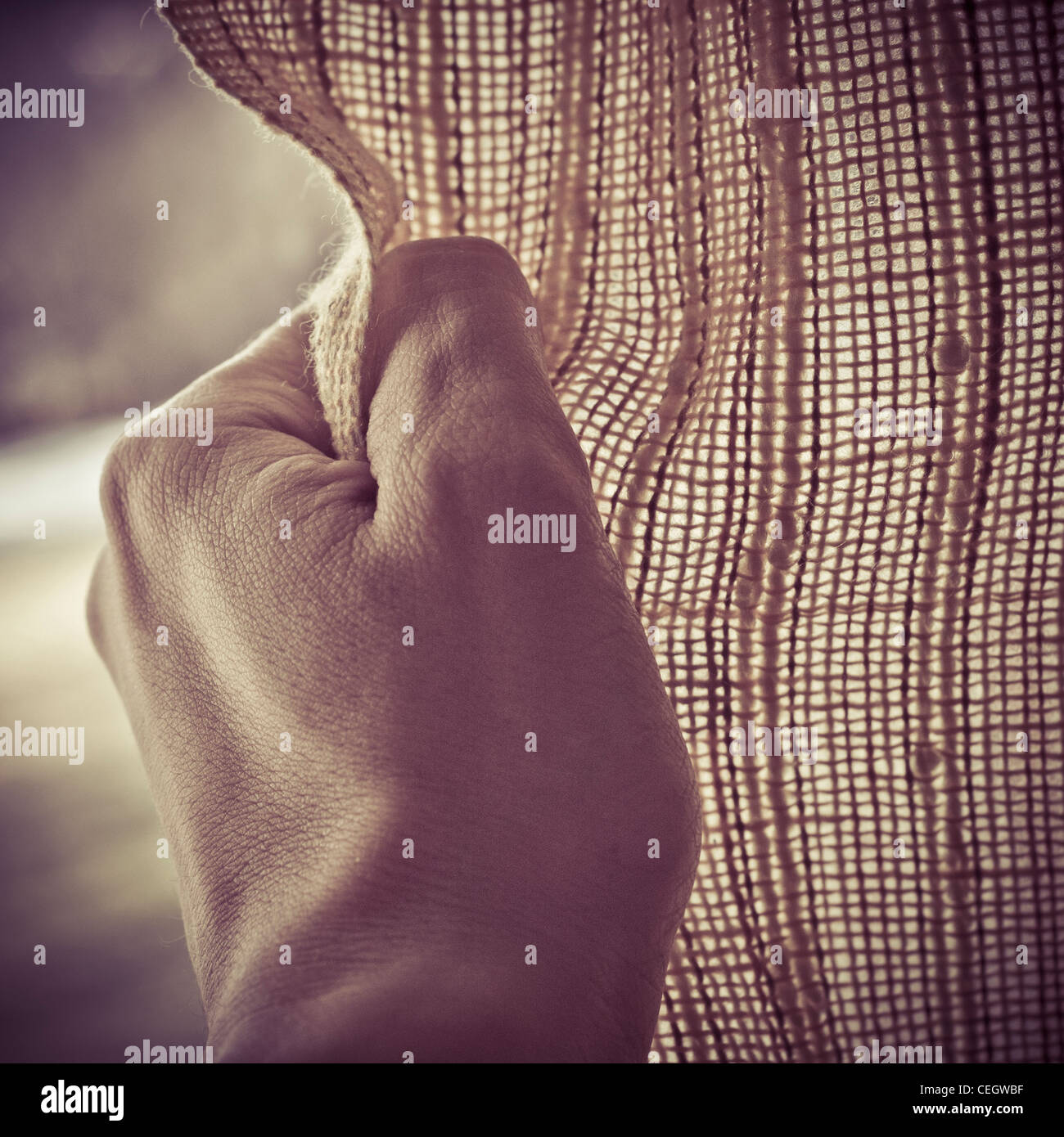 Hand holding a curtain Stock Photo - Alamy