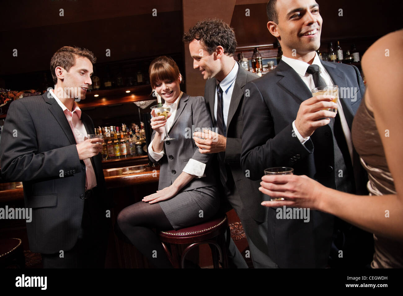 Colleagues drinking together in bar Stock Photo - Alamy