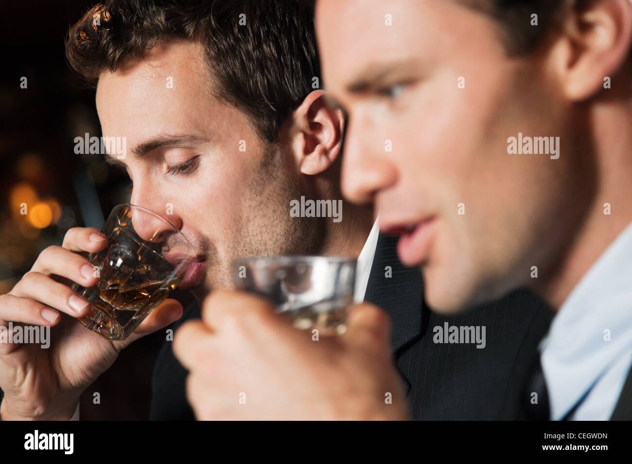 Businessmen drinking shots in bar Stock Photo - Alamy
