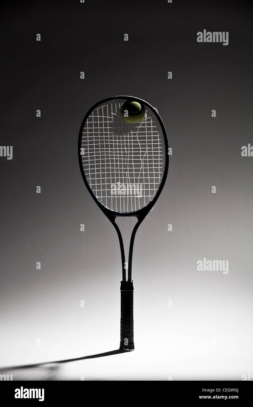 Ball in tennis racket Stock Photo - Alamy