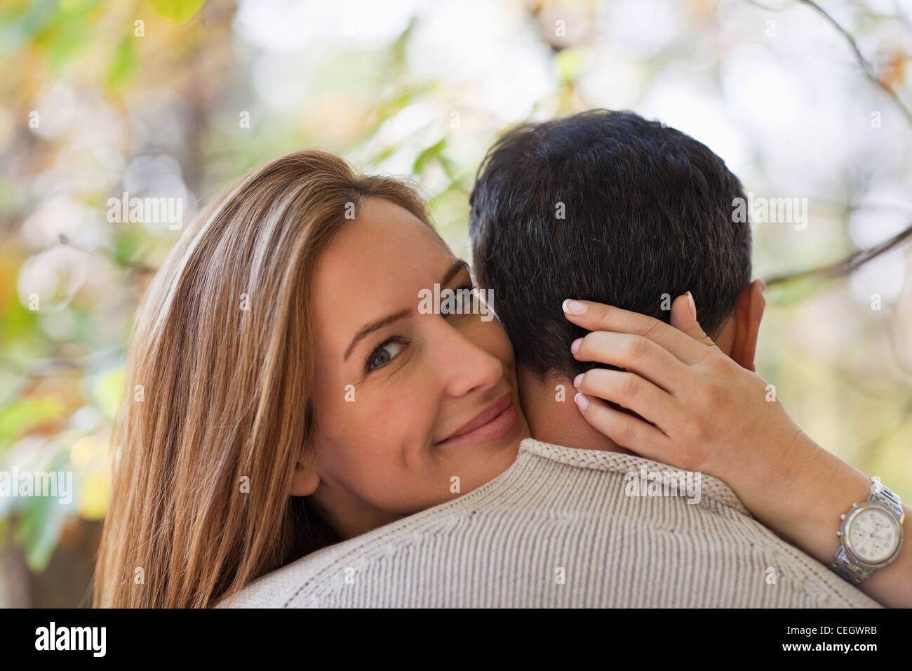 Woman hugging man Stock Photo - Alamy
