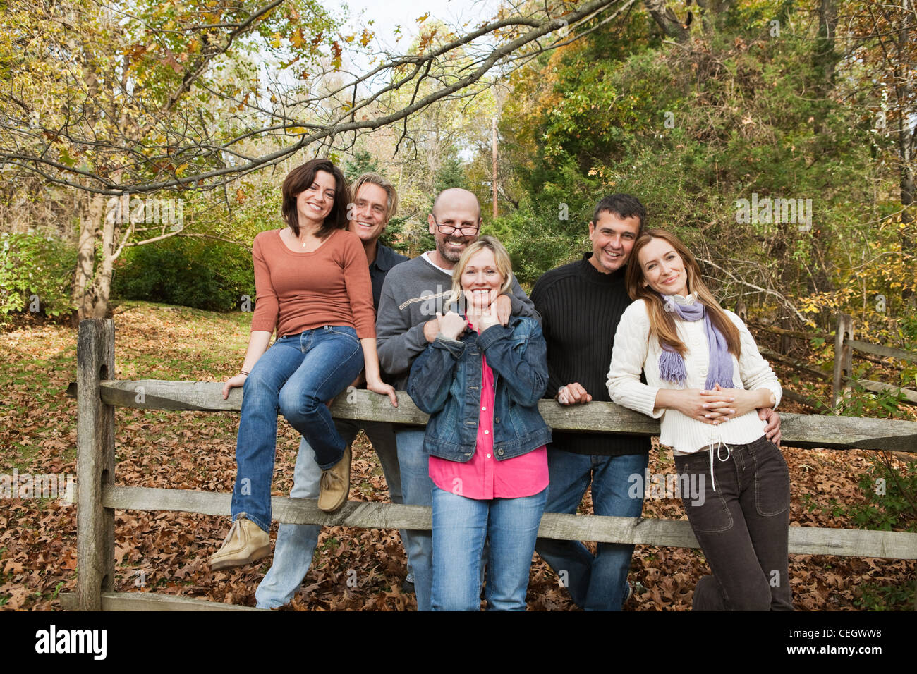 Mature friends around a fence Stock Photo - Alamy