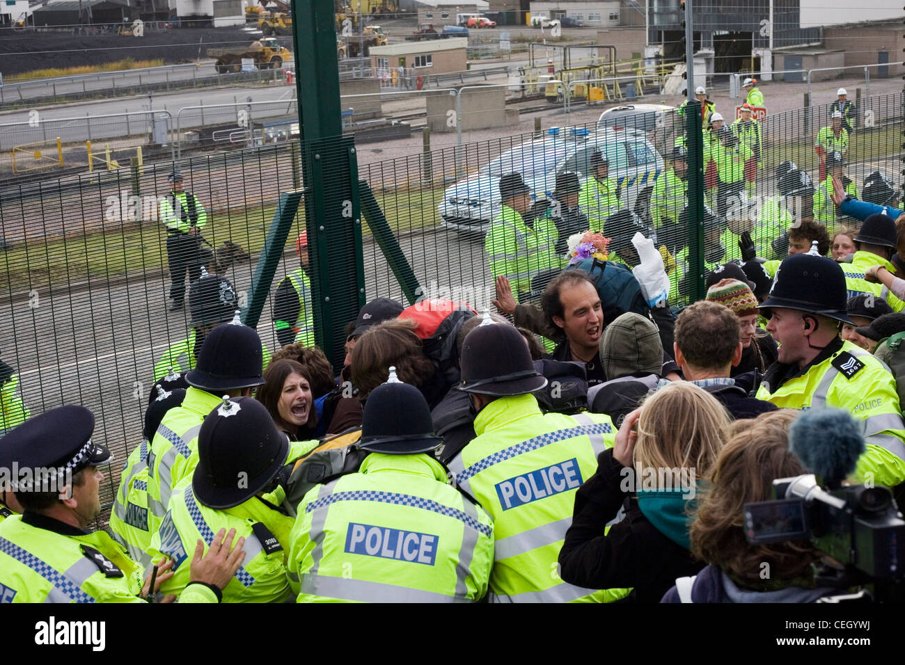 Activists and police officers shouting in a crush against the security ...