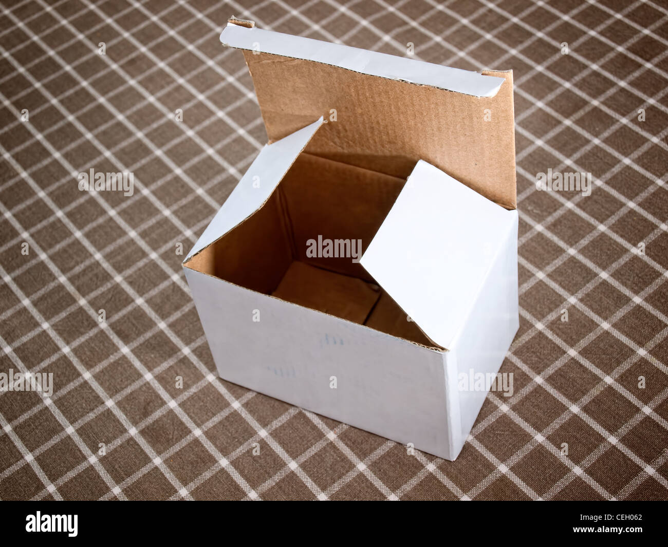 An empty cardboard box on a checked background Stock Photo - Alamy