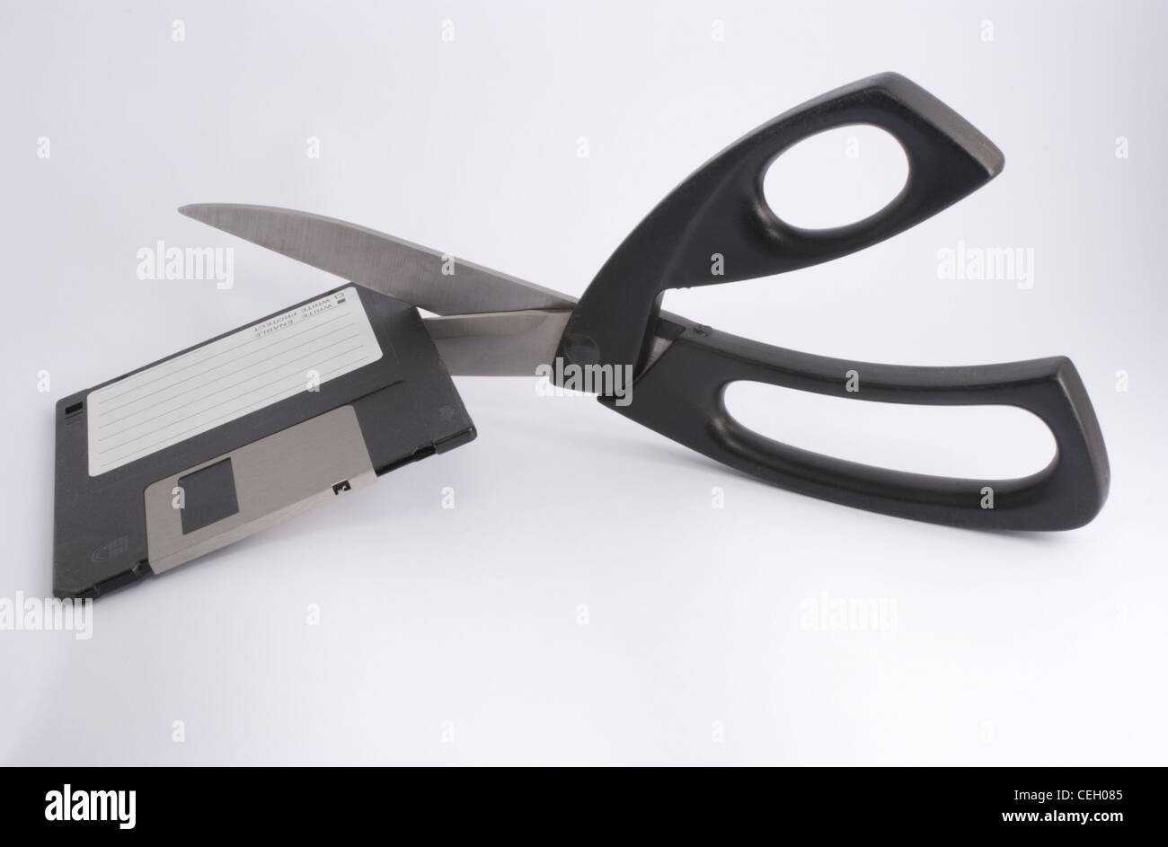 Floppy disk being cut up by a pair of scissors Stock Photo - Alamy