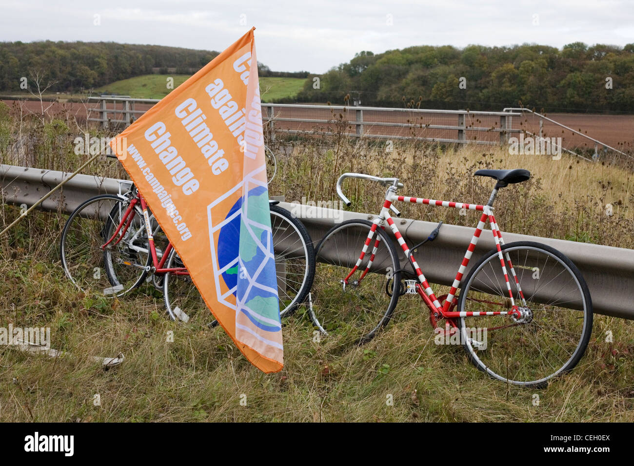Bicycles at the side of the road with Climate change flag Stock Photo ...