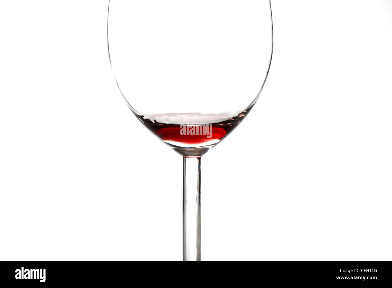 An almost empty red wine glass Stock Photo - Alamy