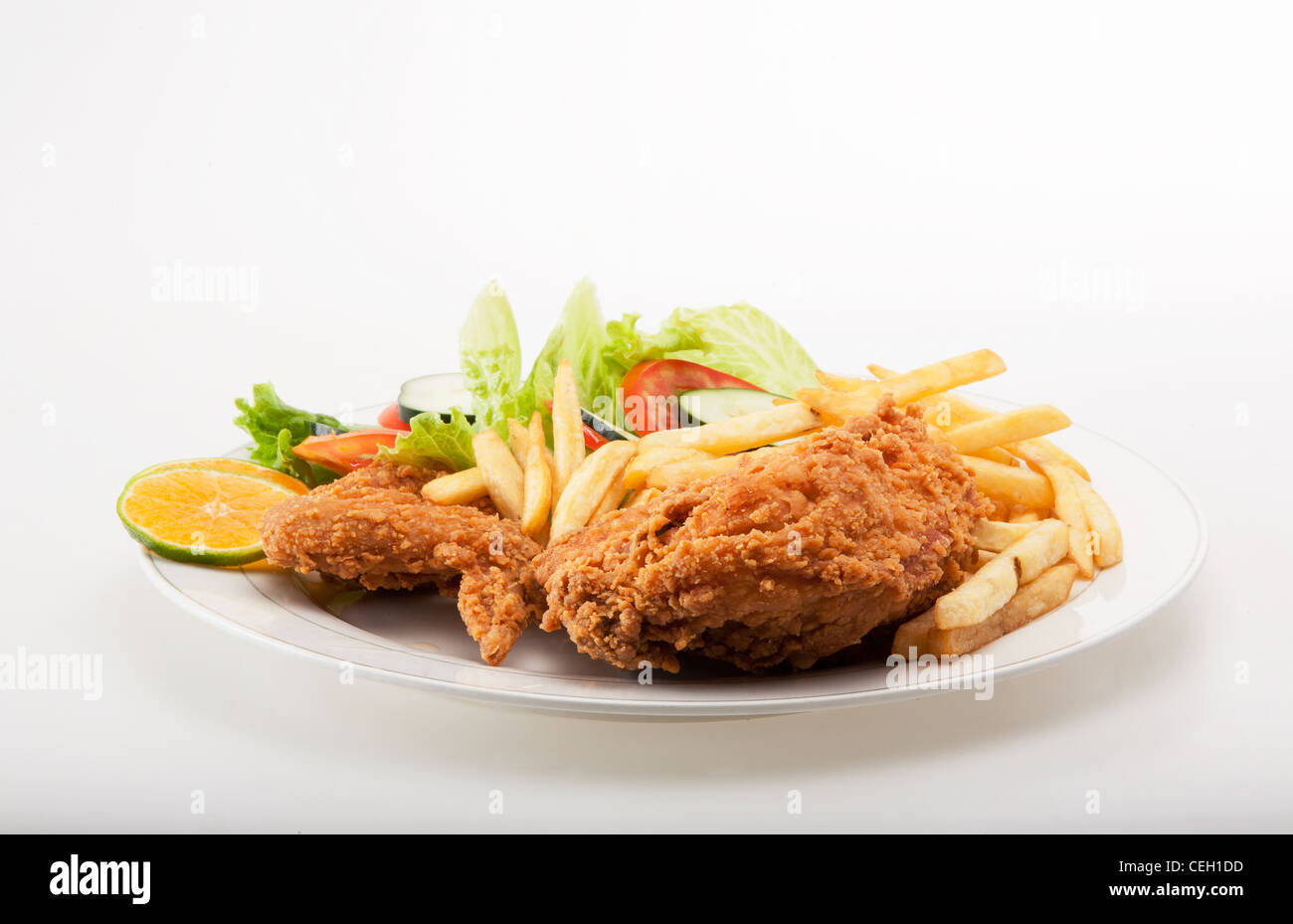 A plate of typical Costa Rican fried chicken with salad, french fries ...