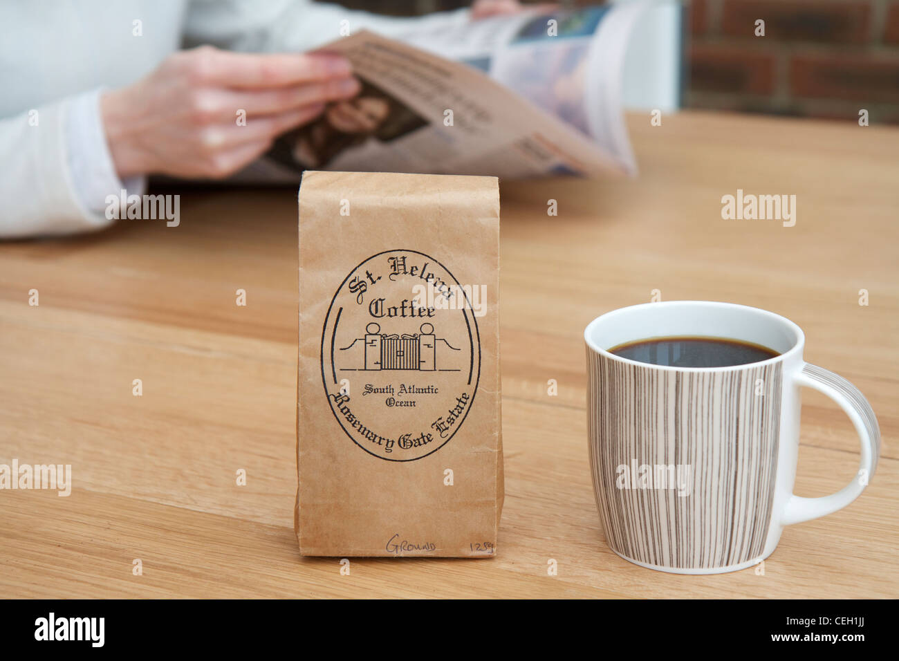 St. Helena Coffee from the South Atlantic and a cup of coffee. A woman ...