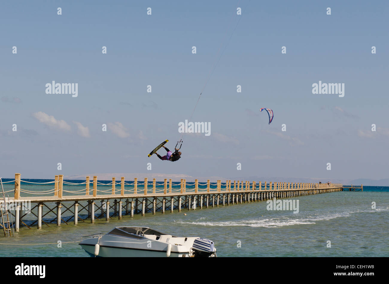Kite surfer jumping near a pier Stock Photo - Alamy