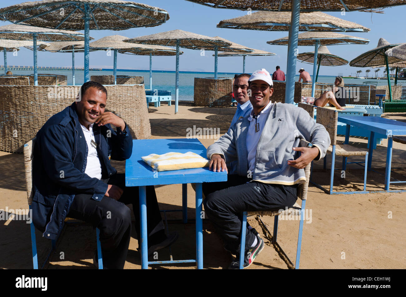 Hotel employees working at the beach Stock Photo - Alamy