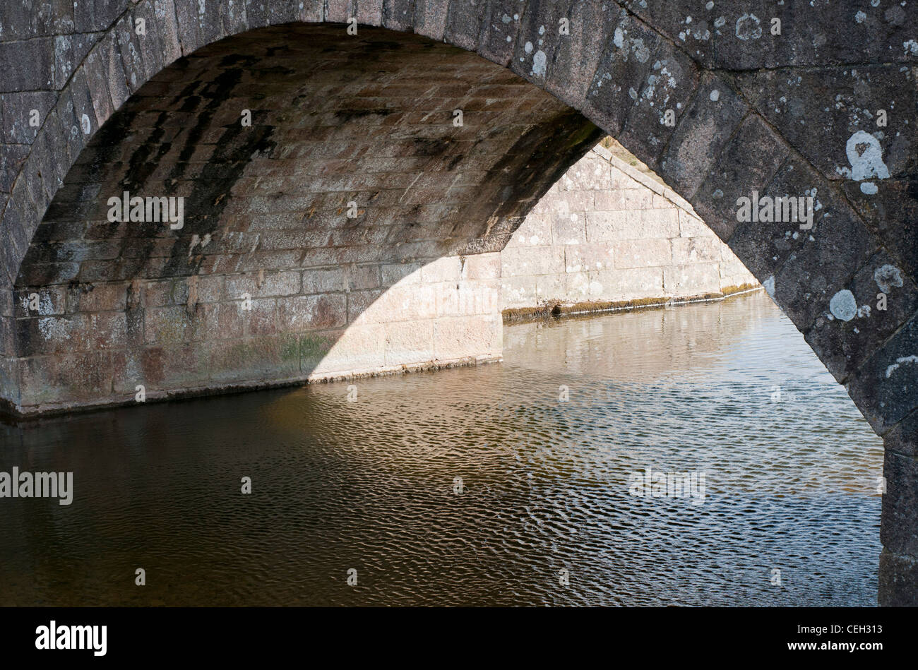 Water flowing under the bridge at Cadover, Dartmoor, Devon UK Stock ...
