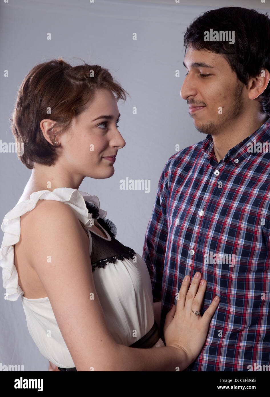 Cute white couple snuggling together, in a tender, romantic moment of ...