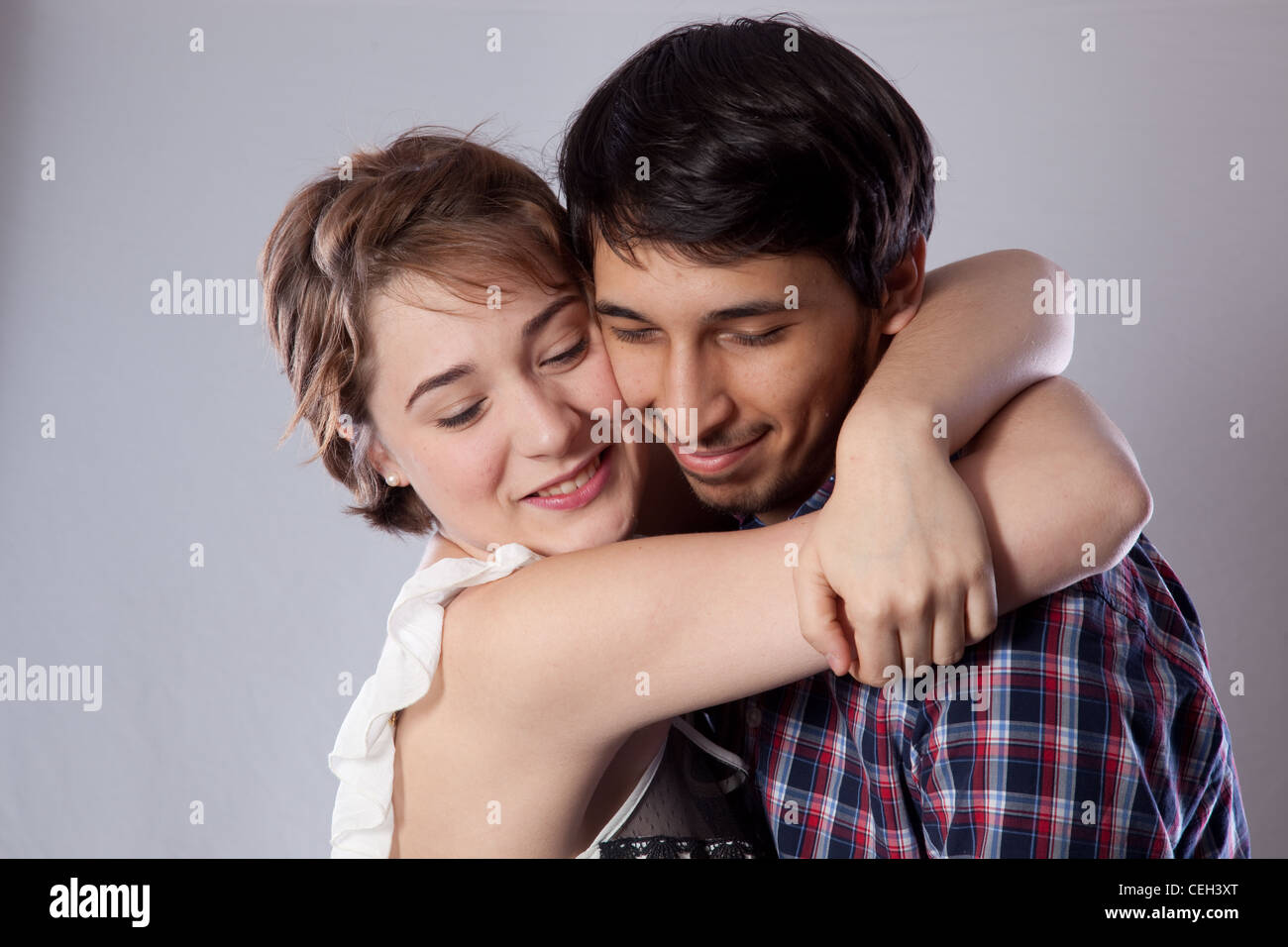 Cute white couple snuggling together, in a tender, romantic moment of ...
