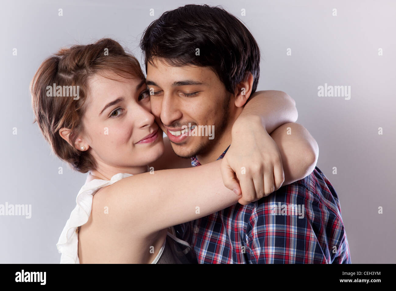 Cute white couple snuggling together, in a tender, romantic moment of ...