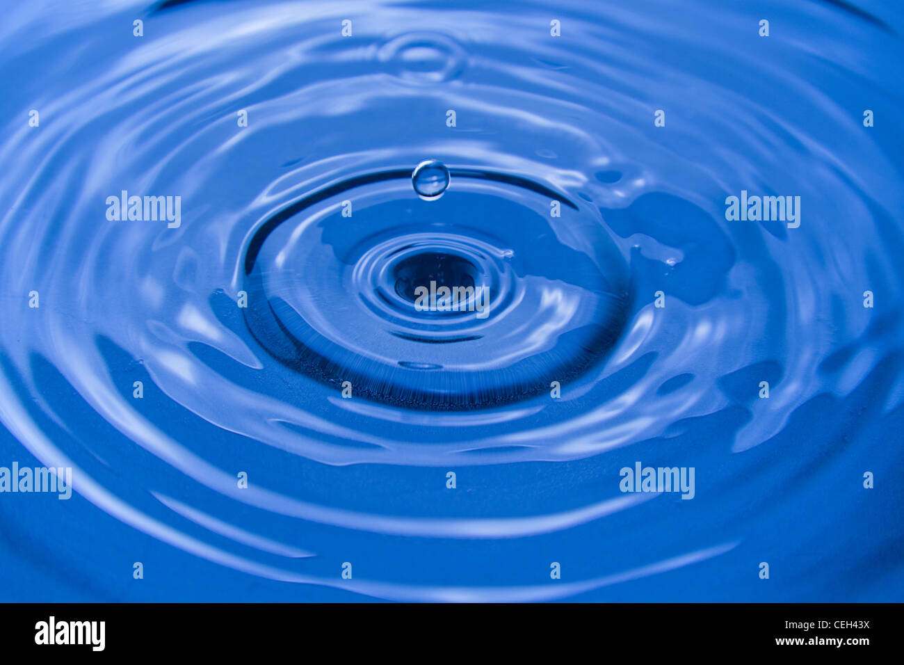 Water drop making a ripple on the surface Stock Photo - Alamy