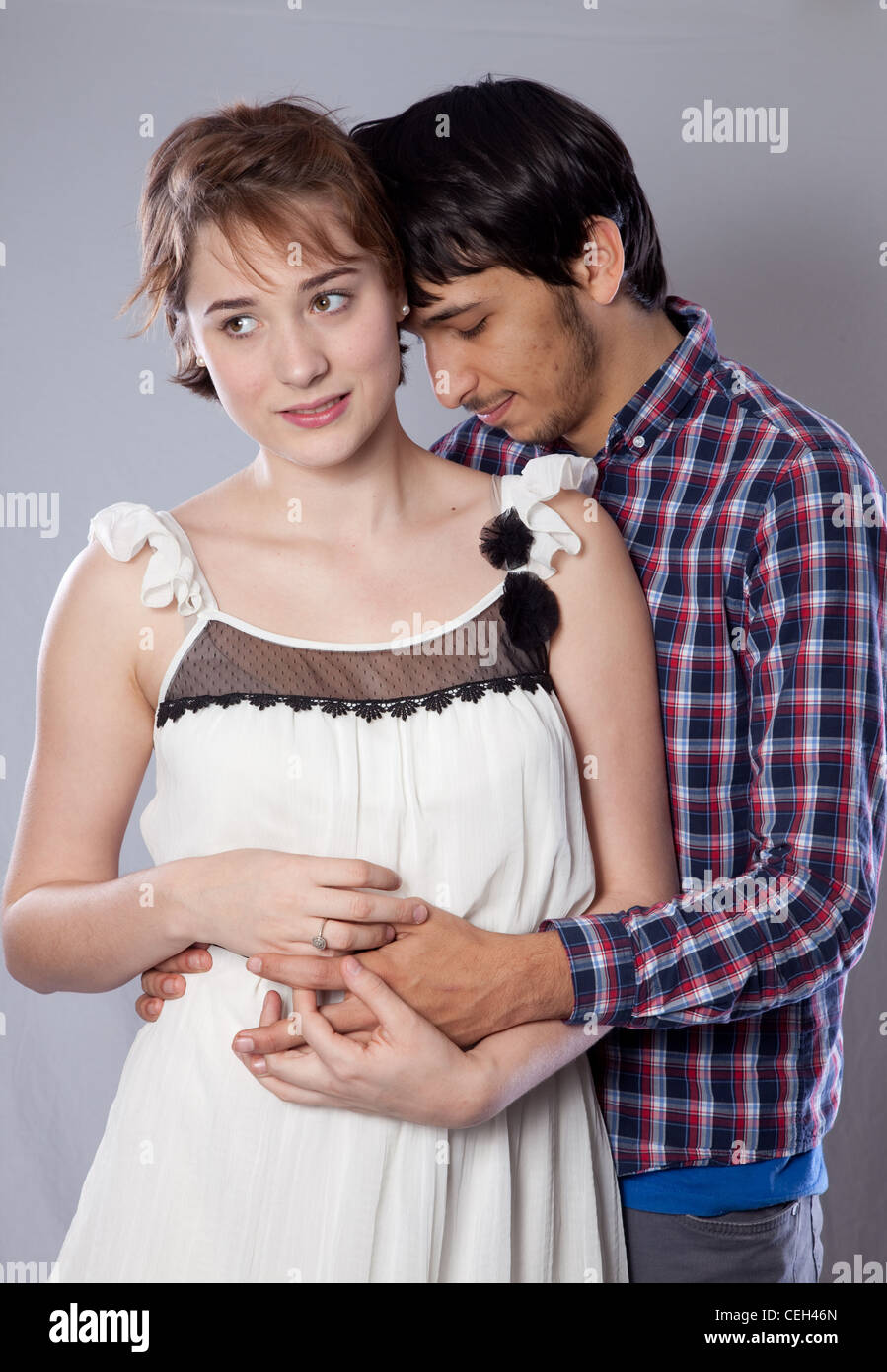 Cute white couple snuggling together, in a tender, romantic moment of ...