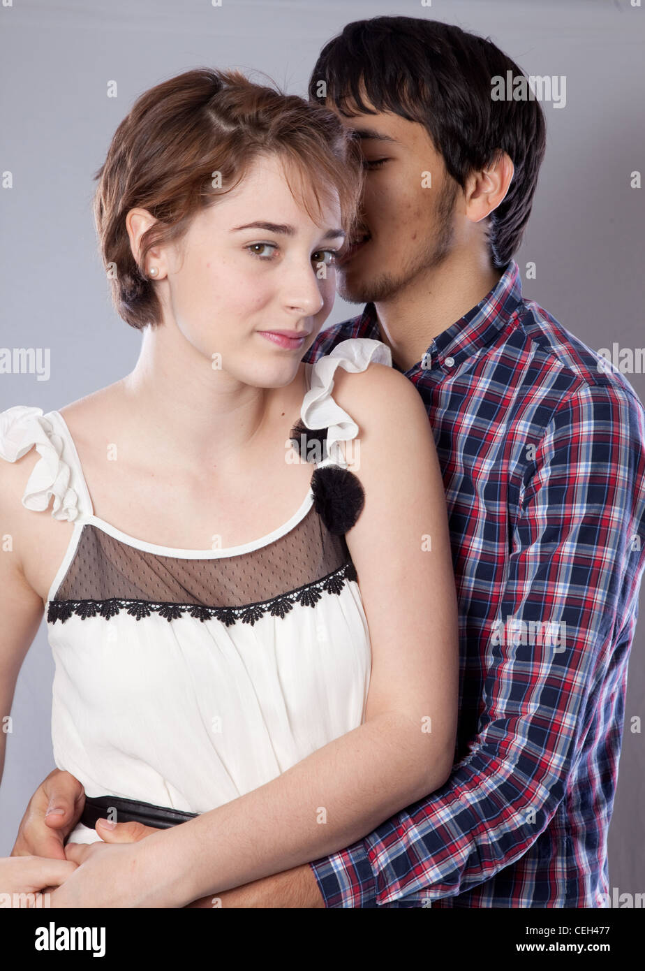 Cute white couple snuggling together, in a tender, romantic moment of ...