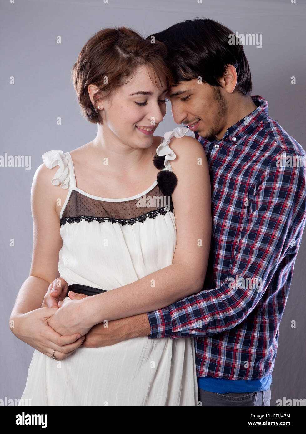 Cute white couple snuggling together, in a tender, romantic moment of ...