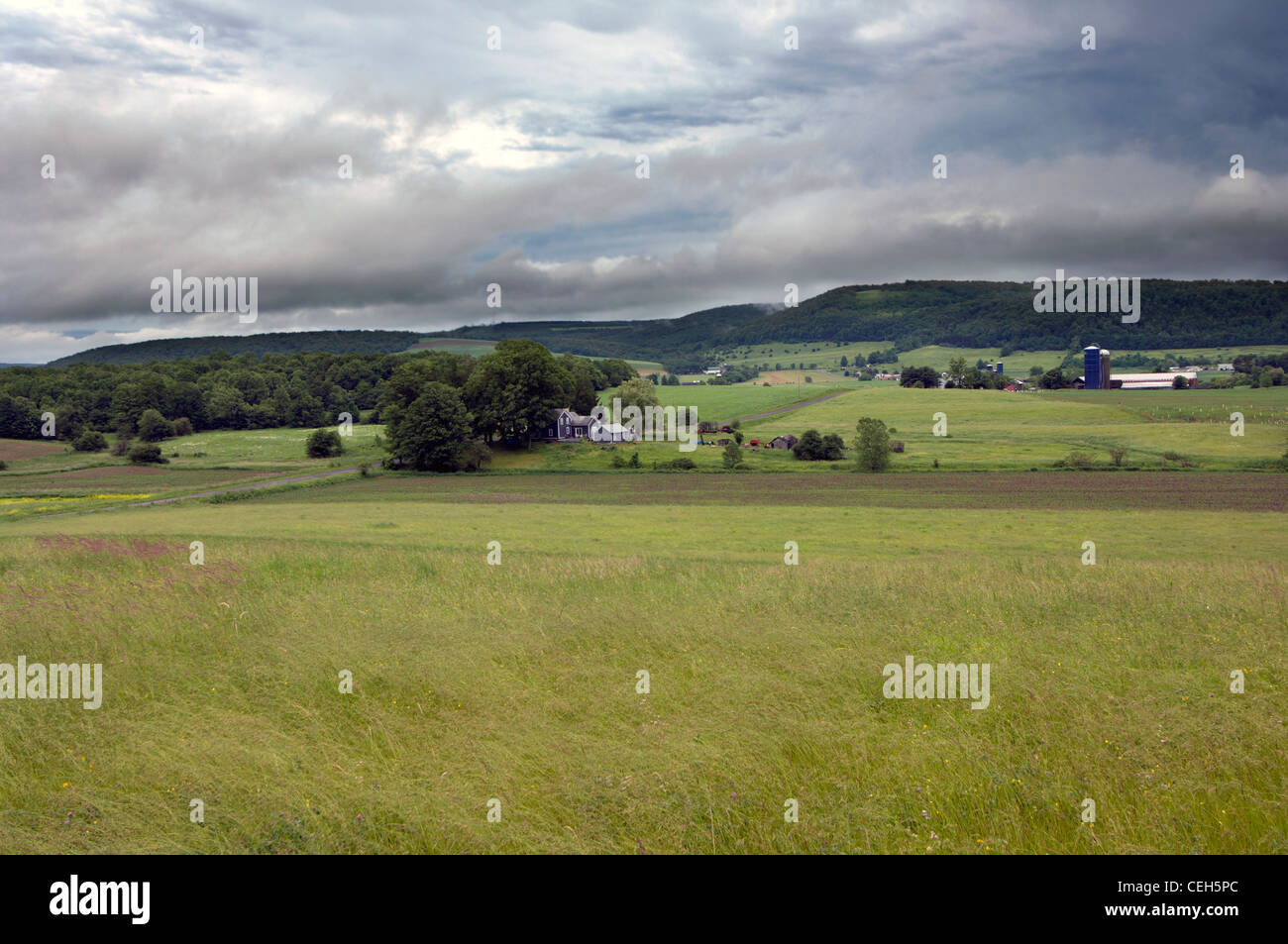 houses and farm buildings seen from across an open field Stock Photo ...