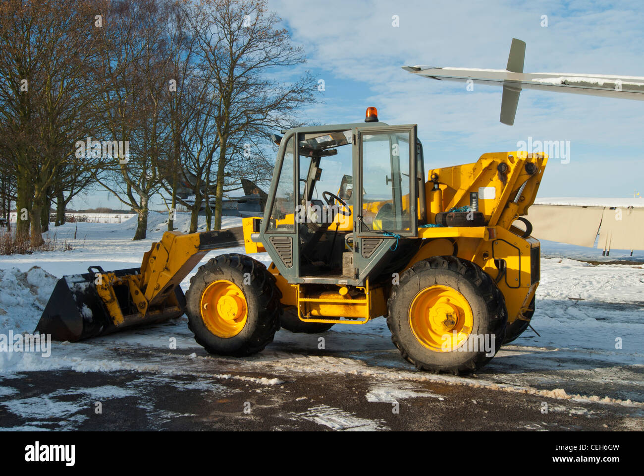 Wheel loader machine moving snow Stock Photo - Alamy