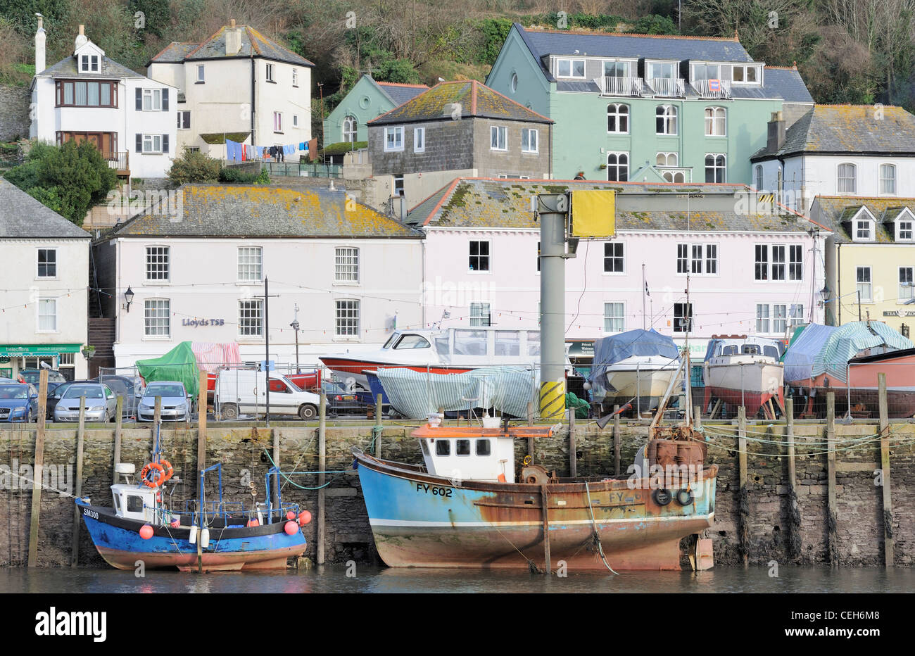 Traditional fishing boats and colored houses in Cornish harbor Stock ...
